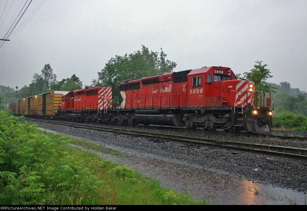 CP 5998 and 5951 head west in the rain